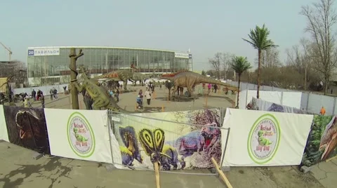People with children walk by Dino-Park w... | Stock Video | Pond5
