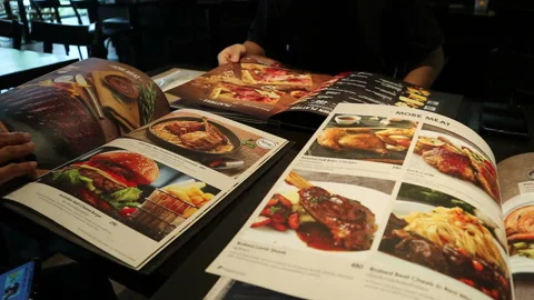 People choosing food from a menu item in... | Stock Video | Pond5