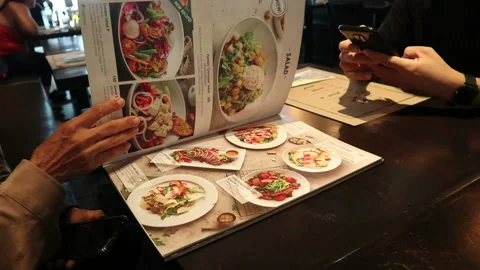 People choosing food from a menu item in... | Stock Video | Pond5