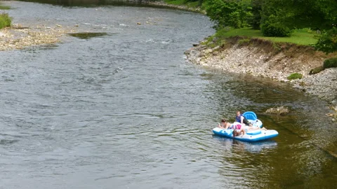 People On Colorful Tube On River As Wate... | Stock Video | Pond5