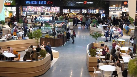 People crowd sit eating on big fast food... | Stock Video | Pond5