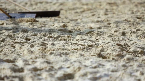 People flatten sand surface at beach vol... | Stock Video | Pond5
