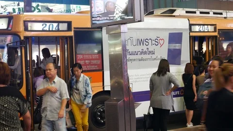 People getting on buses at bus stop in B... | Stock Video | Pond5