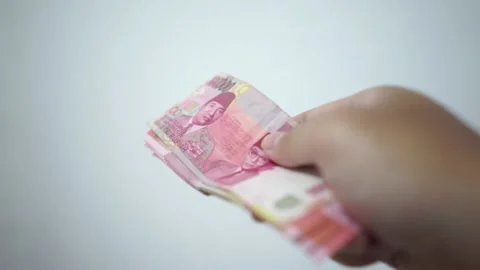 people giving Indonesian rupiah banknote... | Stock Video | Pond5