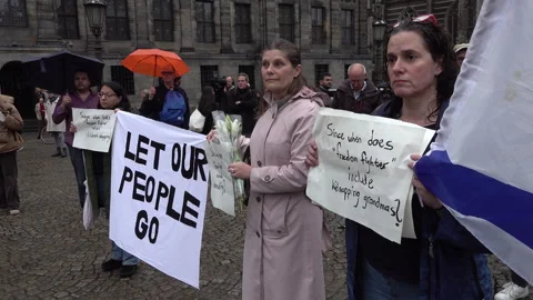 People hold banners about Israeli hostag... | Stock Video | Pond5
