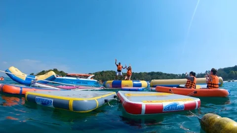people jumping in island summer fun play... | Stock Video | Pond5