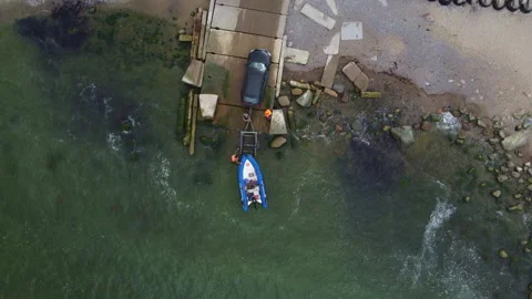 People loading boat on trailer behind ca... | Stock Video | Pond5