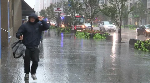 People running for cover in heavy rain w... | Stock Video | Pond5