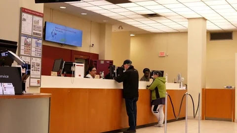 People at service counter talking to the... | Stock Video | Pond5