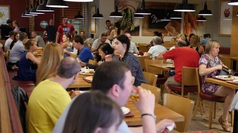 People sit at fast food restaurant table... | Stock Video | Pond5