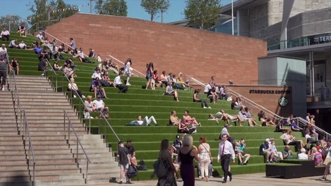 People sit on steps at Liverpool One, En... | Stock Video | Pond5