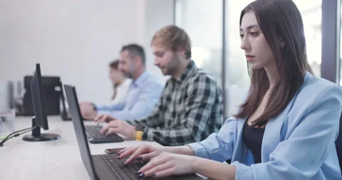 People sitting in a row in office workin... | Stock Video | Pond5