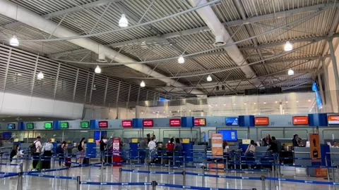 People stand at the check-in counters in... | Stock Video | Pond5