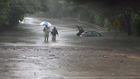 People wading through water and Flooding... | Stock Video | Pond5