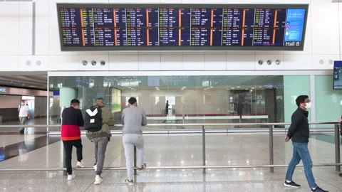 People wait at the arrival hall for pass... | Stock Video | Pond5