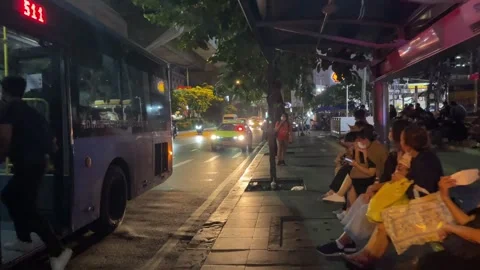 People waiting for a bus at bus stop on ... | Stock Video | Pond5