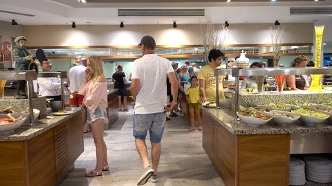 People walk around with their plates and... | Stock Video | Pond5