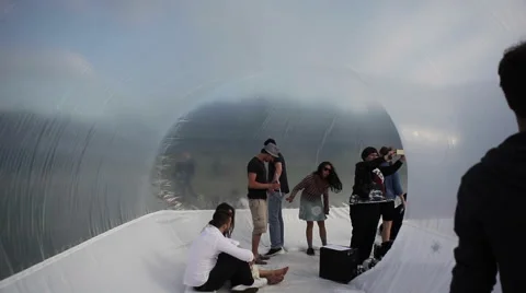 People walk inside plastic bubble art in... | Stock Video | Pond5