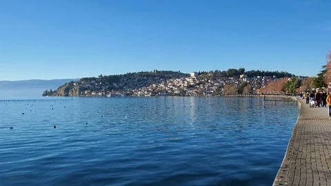 People walking aembankment of Ohrid lake... | Stock Video | Pond5