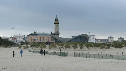 People walking along the beach at Warnem... | Stock Video | Pond5