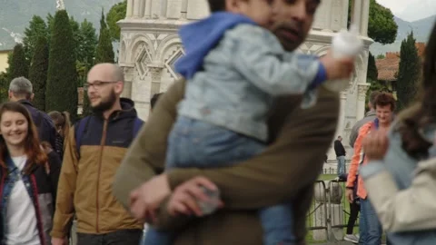 People walking at the base of the leanin... | Stock Video | Pond5