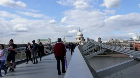 People walking over Millennium Bridge to... | Stock Video | Pond5