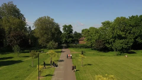 People walking on pathway in park lined ... | Stock Video | Pond5
