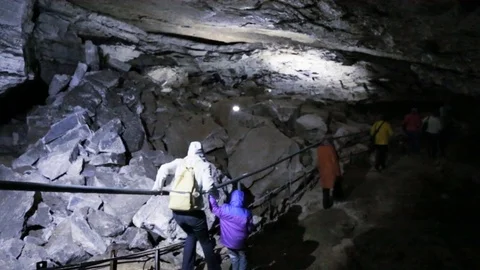 People walking through the cave | Stock Video | Pond5