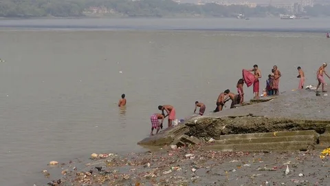 People washing clothes, praying and doin... | Stock Video | Pond5