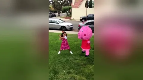 Peppa Pig pinata gets whacked by four-ye... | Stock Video | Pond5