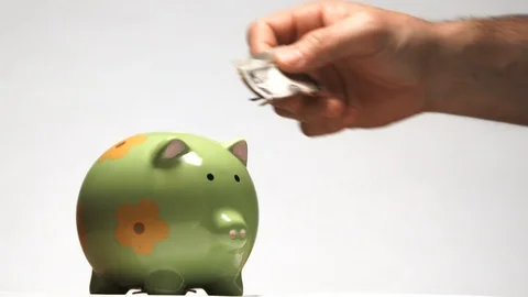 Person Adding Money To Their Piggy Bank ... | Stock Video | Pond5