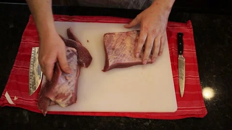 Person butchering beef meat in the kitch... | Stock Video | Pond5