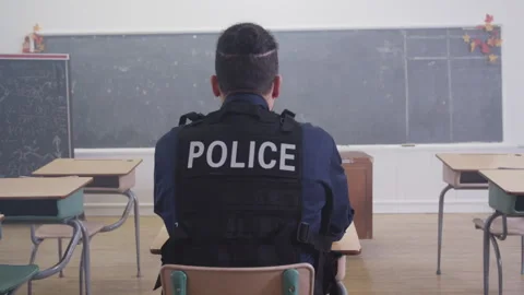 Person of color police officer in a clas... | Stock Video | Pond5