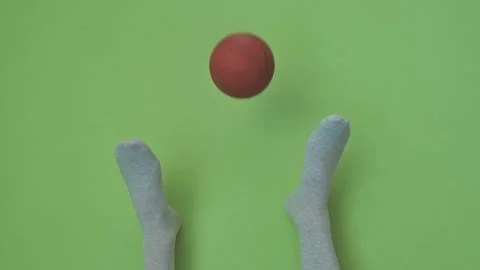 Person with feet on a wall throws a mini... | Stock Video | Pond5