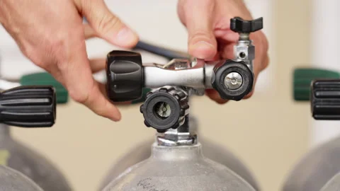 Person filling compressed air in scuba d... | Stock Video | Pond5