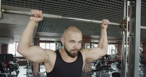 A person in the gym builds up muscles an... | Stock Video | Pond5