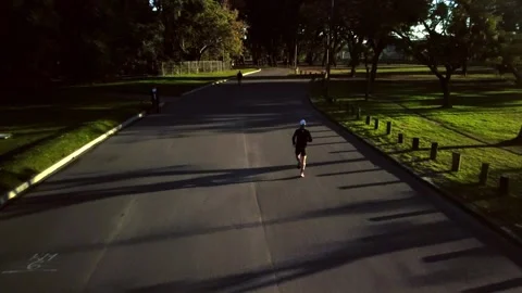 Person jogging in park, back view. Man r... | Stock Video | Pond5
