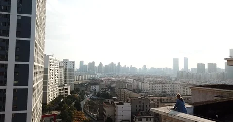 Person looking over the city from a roof... | Stock Video | Pond5