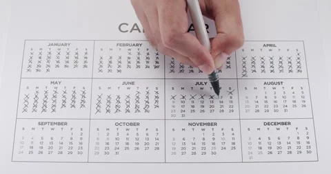 Person Marking Dates on Yearly Calendar ... | Stock Video | Pond5