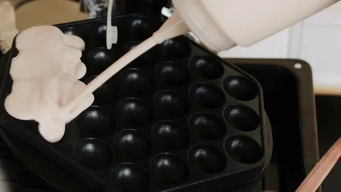 Person pouring waffle mixture in a waffl... | Stock Video | Pond5