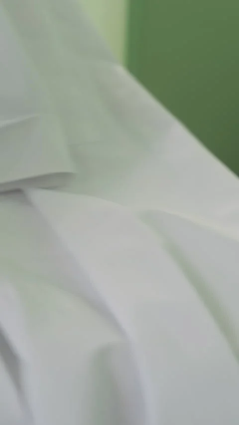 Person Reaching for Lab Coat Draped Over... | Stock Video | Pond5