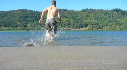 Person Running And Diving Into Refreshin... | Stock Video | Pond5