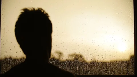 Person silhouette staring through window... | Stock Video | Pond5