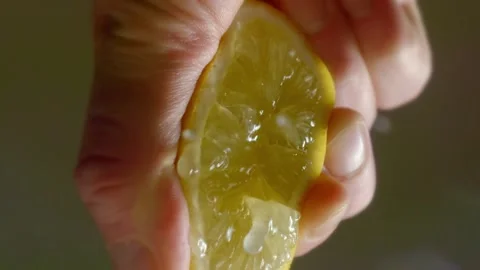Person Squeezes Sliced Lemon Half Splash... | Stock Video | Pond5