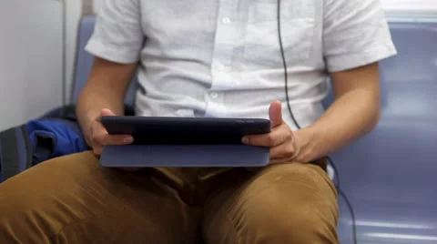Person on subway train using tablet 4k | Stock Video | Pond5