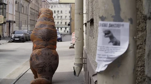 Person in t rex mascot walking away from... | Stock Video | Pond5
