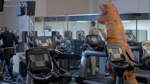 Person In A T-Rex Suit Working Out On Th... | Stock Video | Pond5