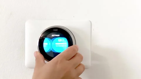 A person using a Nest learning smart the... | Stock Video | Pond5