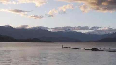 Person walking on the pier in sea at sun... | Stock Video | Pond5