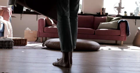 Person walking into room and dropping ov... | Stock Video | Pond5